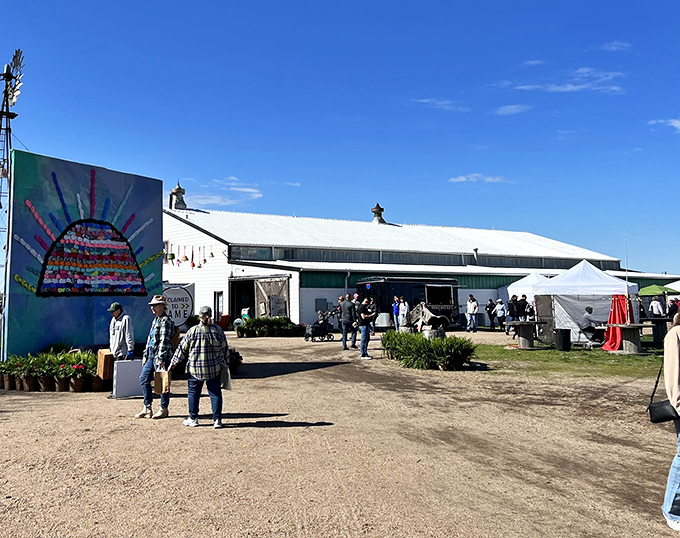 The white barn with its colorful mural welcomes treasure hunters like a beacon of vintage hope in the Nebraska countryside.
