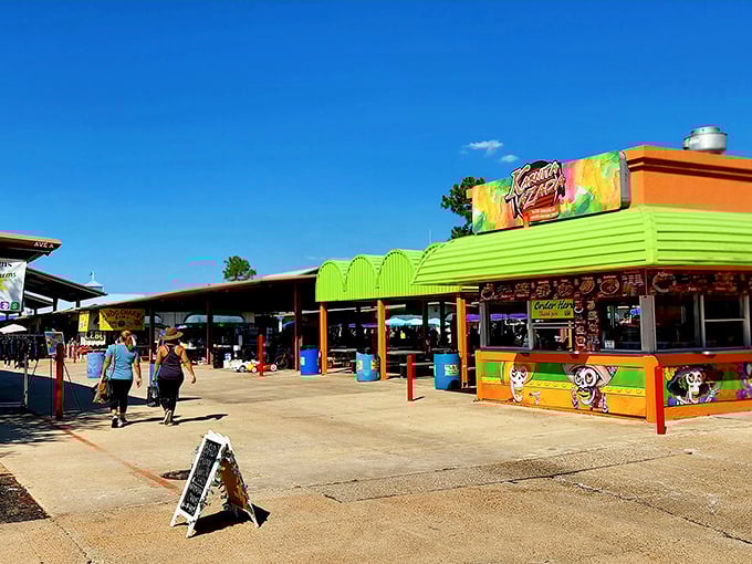The vibrant food stalls at Traders Village pop with color against the Texas sky, promising flavors as bold as their paint jobs.