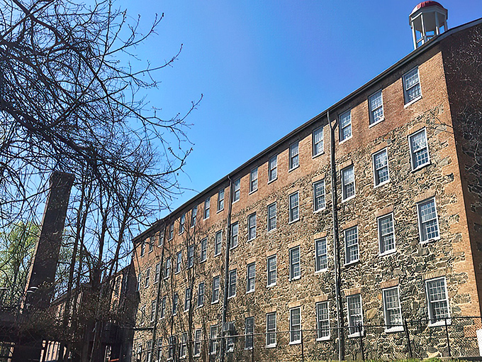 The historic brick façade of Rams Head Tavern at Savage Mill welcomes visitors with architectural charm that whispers stories from Maryland's industrial past.