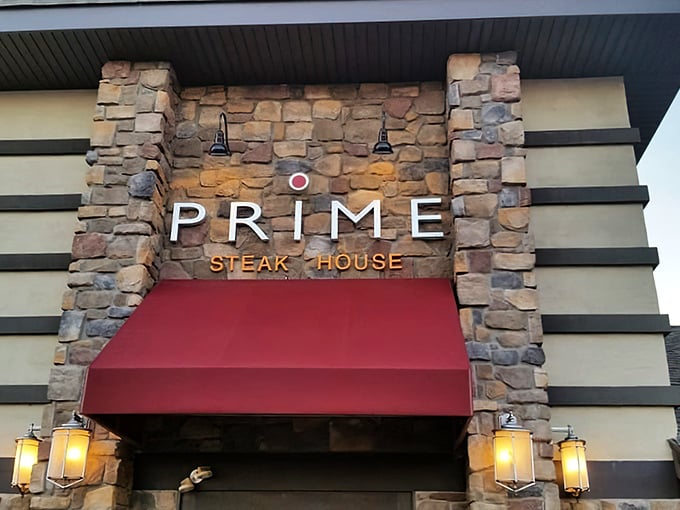 The stone facade of Prime Steak House welcomes hungry travelers with its distinctive red awning and warm lighting—a carnivore's lighthouse on the Bethlehem horizon.