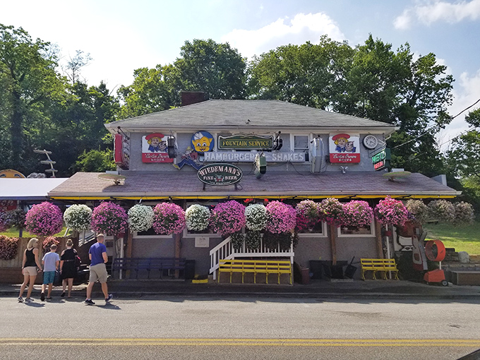 The Turf Club's exterior is a delightful contradiction – part roadside attraction, part culinary institution, with vintage figurines standing guard over burger paradise.