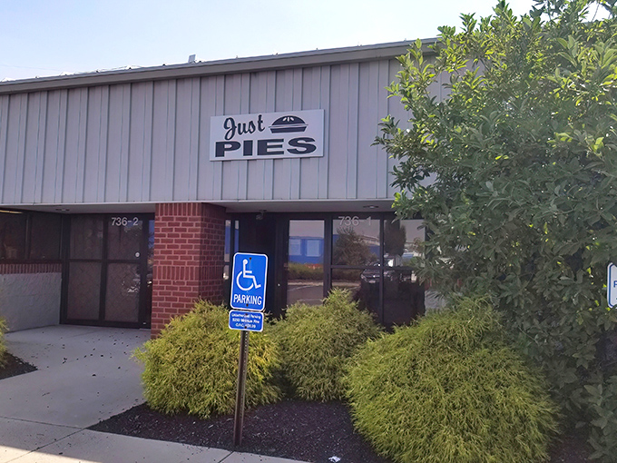 The unassuming exterior of Just Pies proves once again that culinary greatness rarely comes with flashy packaging.