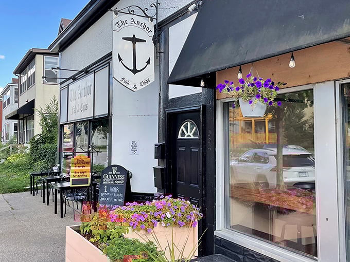 The classic black and white signage of The Anchor Fish & Chips stands as a beacon of British comfort food in Northeast Minneapolis.