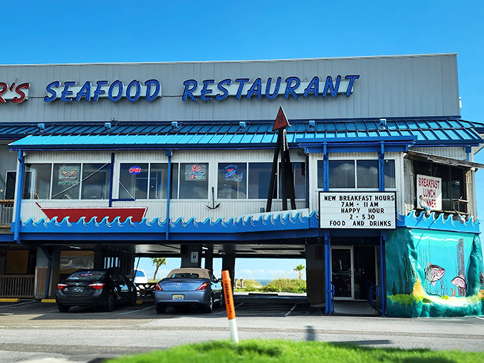 Snapper's iconic blue-trimmed exterior stands like a beacon for seafood lovers, with parking cleverly tucked underneath—Gulf Coast practicality at its finest.