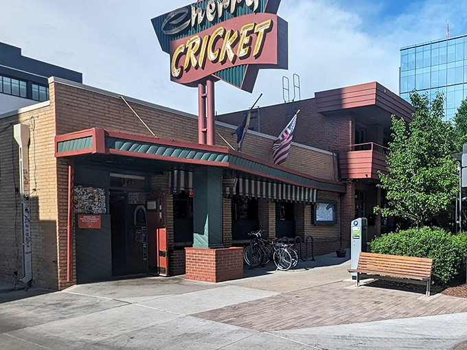 The iconic Duffy's Cherry Cricket sign stands as a beacon of burger bliss in Denver's Cherry Creek neighborhood, promising unpretentious delights within those brick walls.
