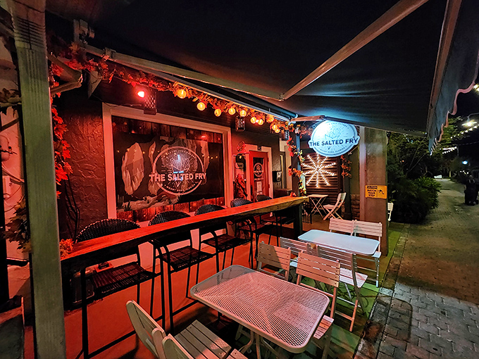 The bright orange outdoor seating at The Salted Fry beckons like a potato-loving friend, promising crispy delights behind that cheerful red door in downtown Mount Dora.