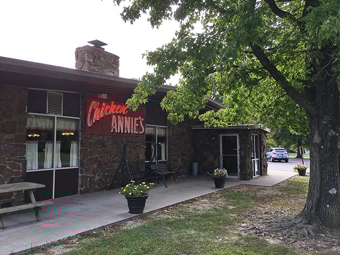 The stone facade and iconic red sign of Chicken Annie's Original stands as a monument to fried chicken perfection in Pittsburg, Kansas.