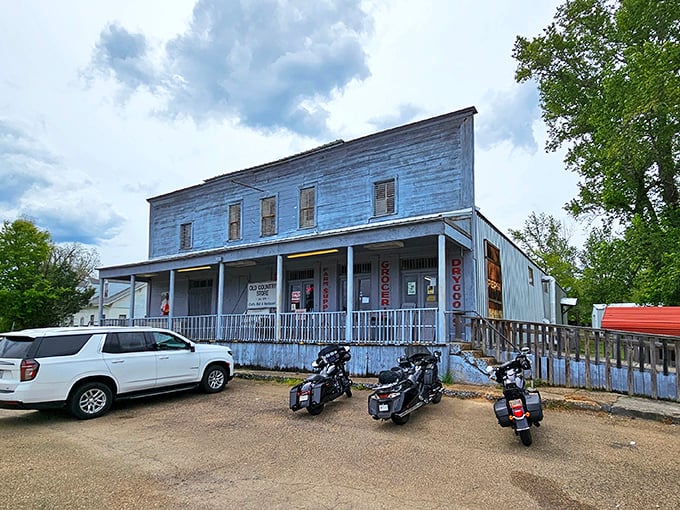 The weathered white clapboard exterior of The Old Country Store stands as a time capsule on Highway 61, promising culinary treasures within its humble walls.