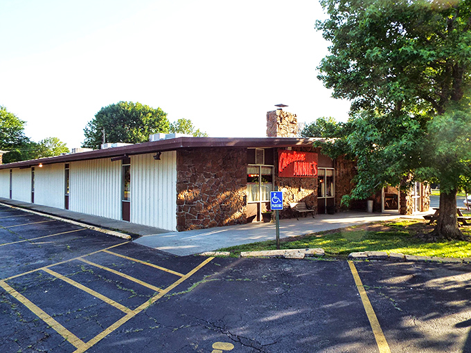 The stone facade and iconic red sign of Chicken Annie's Original stands as a monument to fried chicken perfection in Pittsburg, Kansas.