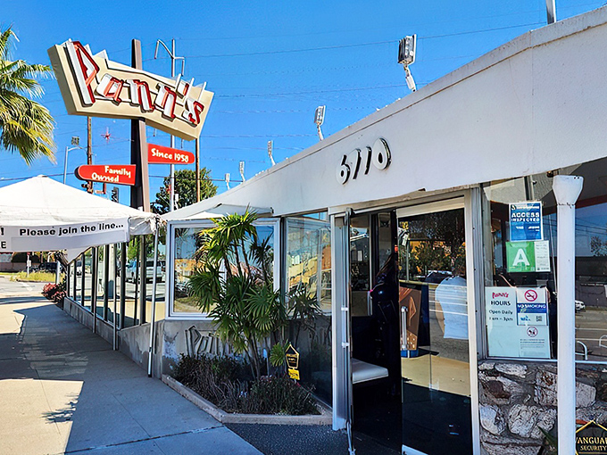 That iconic angular roof and neon sign aren't just eye-catching—they're a time portal to mid-century Los Angeles when optimism came supersized.