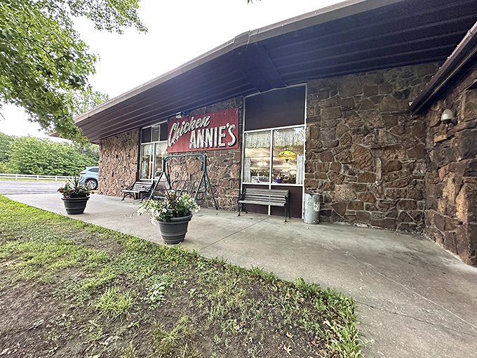 The stone facade and iconic red sign of Chicken Annie's Original stands as a monument to fried chicken perfection in Pittsburg, Kansas.