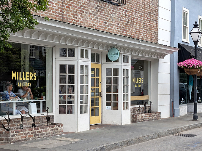 The charming storefront of Millers All Day beckons with its classic brick exterior and cheerful yellow door—like Charleston itself, both elegant and welcoming.
