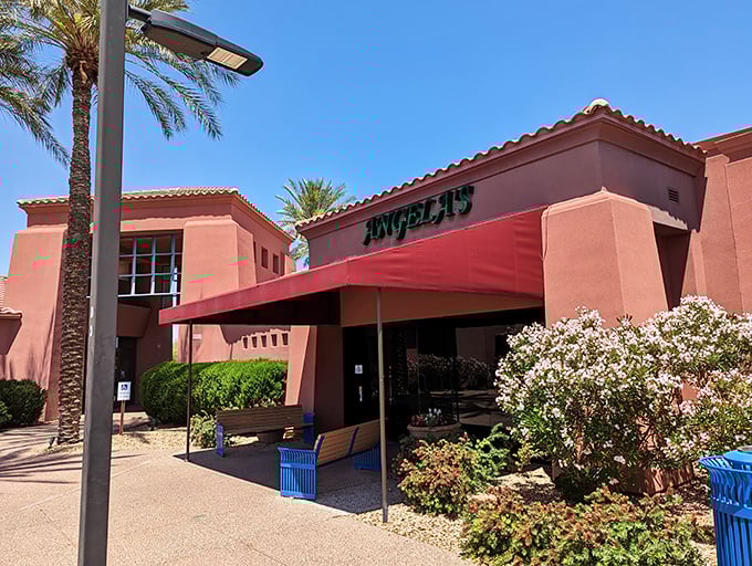 Angela's Kitchen welcomes you with its warm terracotta exterior and inviting red awning—a culinary oasis amid the Arizona desert landscape.