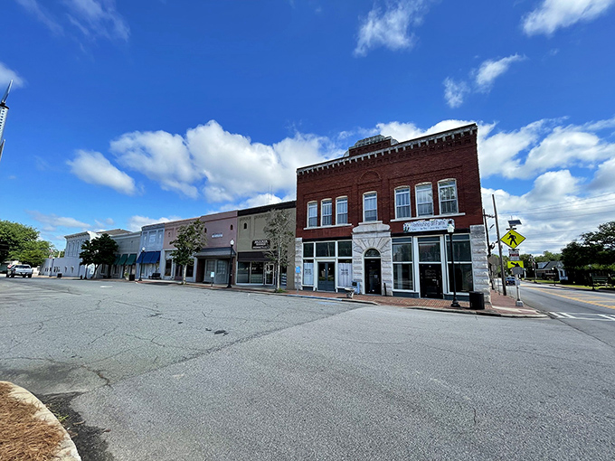 Historic charm meets small-town affordability along Sandersville's main street, where colorful storefronts welcome visitors with Southern hospitality and brick-paved sidewalks.