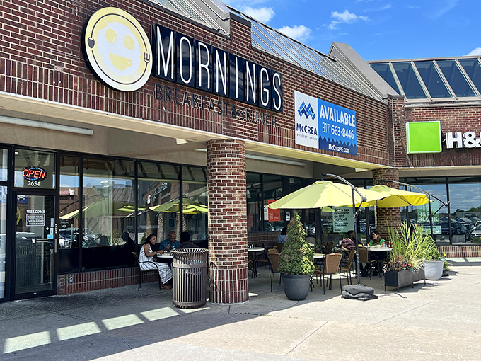 The cheerful yellow smiley face logo seems to know something you don't yet—that breakfast nirvana awaits behind those brick walls.