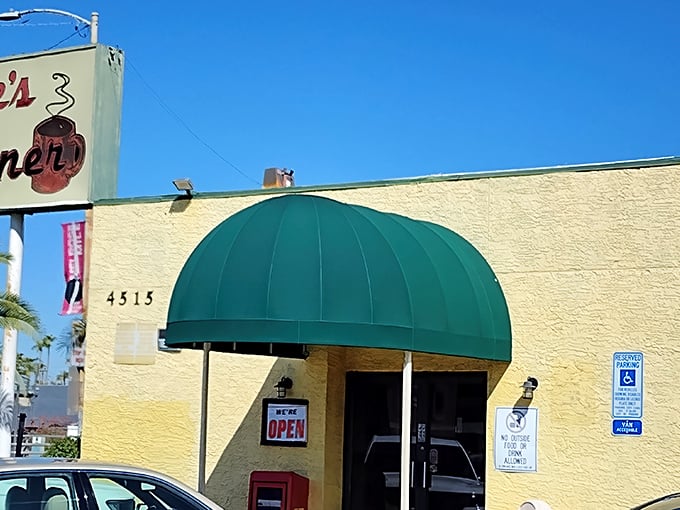 The unassuming exterior of Joe's Diner stands like a beacon of breakfast hope in Phoenix, promising hash brown nirvana behind that green awning.