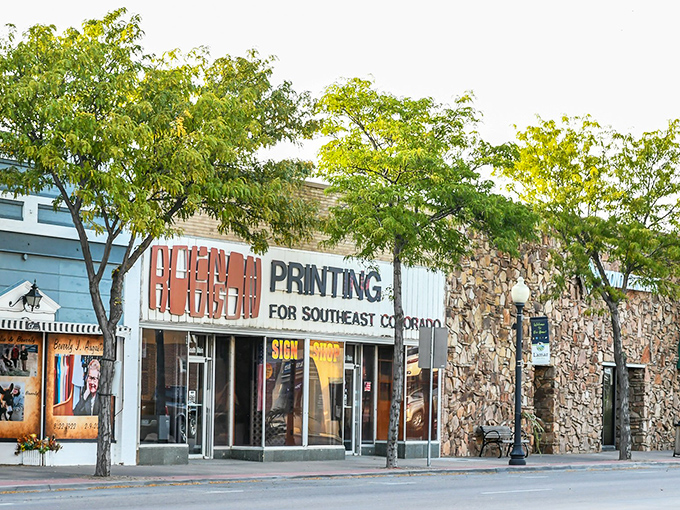 Main Street Lamar welcomes visitors with its classic small-town charm. Those red banners aren't just decorative—they're practically waving "affordable living this way!"