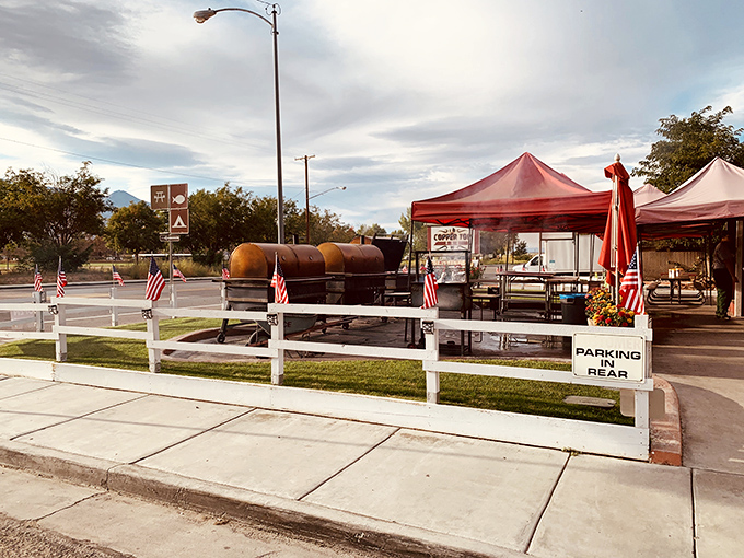 The iconic red barn-like exterior of Copper Top BBQ, where those massive smokers out front aren't just for show—they're the source of that heavenly aroma that hits you from a quarter-mile away.