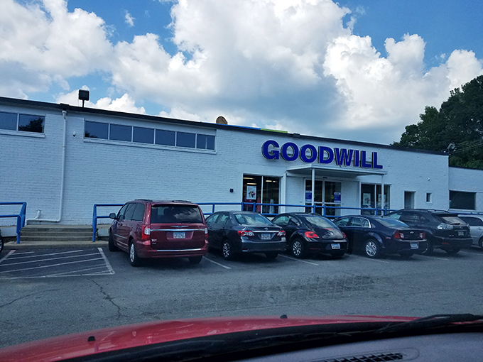 The unassuming white building with bold blue lettering promises treasure hunting adventures that fancy boutiques simply can't match.