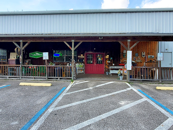 The unassuming exterior of Antique City Mall beckons with its rustic charm and iconic red door – Florida's time machine disguised as a country store.