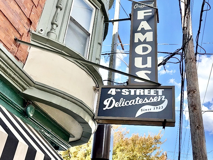 The green and white façade of Famous 4th Street Delicatessen stands like a beacon of culinary tradition on a Philadelphia corner, promising delicious memories in the making.