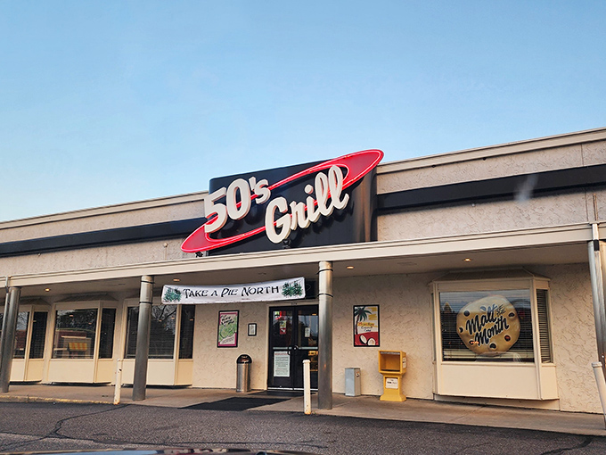 The retro red-and-white sign beckons like a time machine disguised as a restaurant. 50's Grill stands proudly against Minnesota's ever-changing skyline, promising comfort inside.