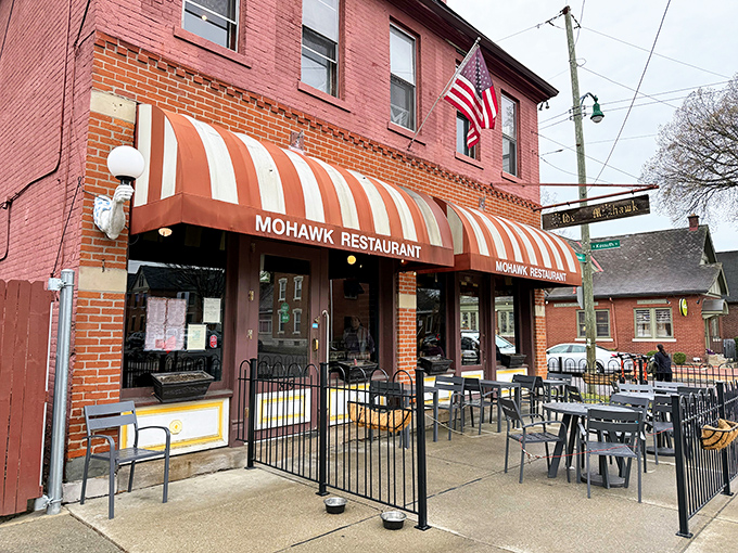 That iconic striped awning isn't just a canopy—it's a beacon for hungry souls wandering German Village after dark. Comfort food salvation awaits.