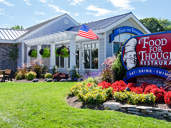 The welcoming exterior of Food For Thought beckons with colorful landscaping and a promise of culinary enlightenment. That American flag isn't just patriotic—it's signaling your taste buds to stand at attention.