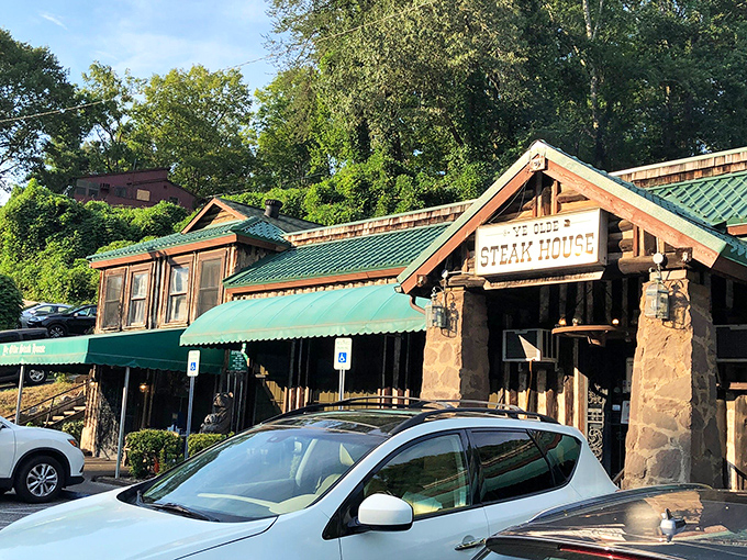 The stone facade and illuminated sign of Ye Olde Steak House beckons like a carnivore's lighthouse on a dark Tennessee night.