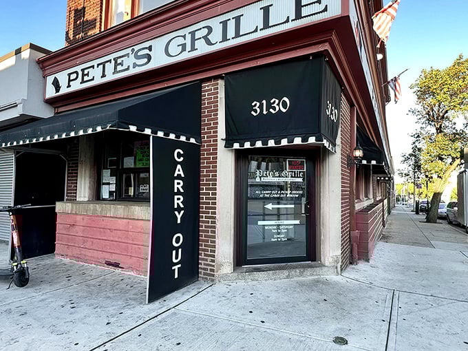 The iconic red brick corner that houses Pete's Grille stands like a beacon of breakfast hope on Greenmount Avenue, promising pancake perfection inside.