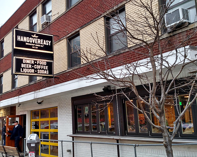 The iconic red door and yellow windows of HangOverEasy stand out like a beacon of breakfast hope on Neil Avenue. Morning salvation awaits inside.
