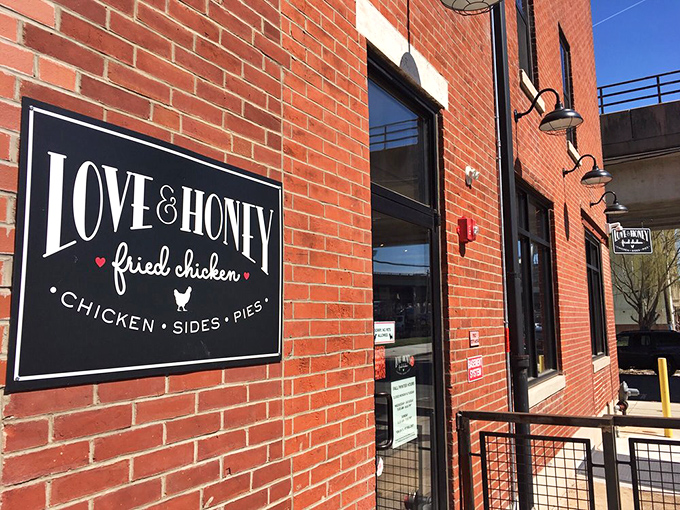 The iconic black sign against red brick announces your arrival at chicken paradise. No fancy frills needed when what's inside speaks this loudly.