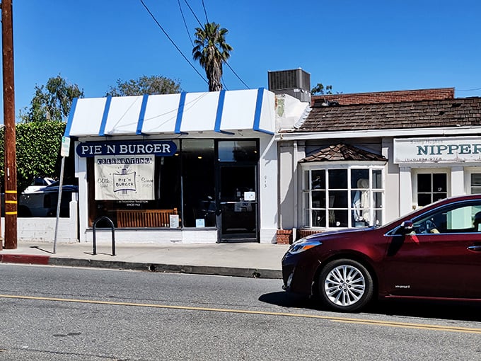 The iconic blue-trimmed storefront beckons like a time portal to simpler days when burgers were burgers and pies were the grand finale, not an afterthought.