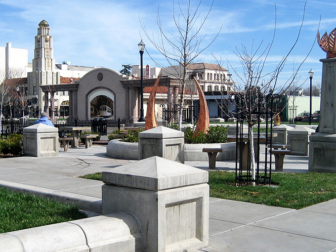 Downtown Chico's city plaza showcases architectural charm with its iconic arches and sculptures – a pocket of urban elegance surrounded by shady trees.