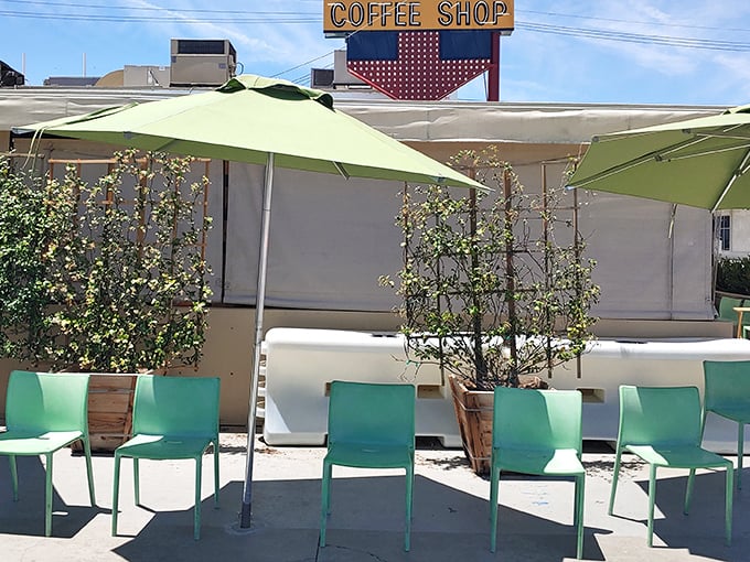The ivy-covered exterior of 24th Street Cafe stands like a verdant oasis in Bakersfield, its vintage "Coffee Shop" sign promising comfort food treasures within.
