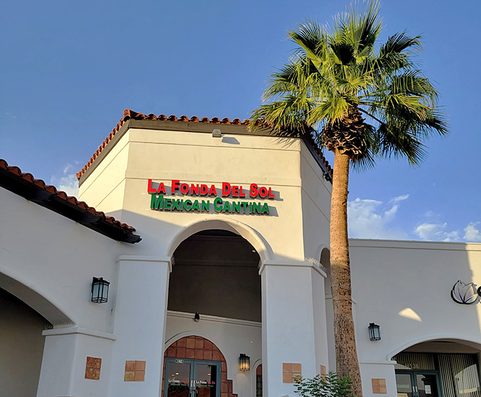 The iconic terra cotta roof and vibrant red-and-green signage of La Fonda Del Sol promises authentic Mexican flavors before you even step inside.