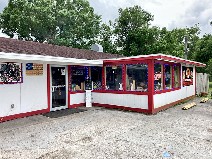 The little roadside building with the red trim isn't trying to impress anyone—until you taste what comes out of that kitchen. Classic Florida diner magic.
