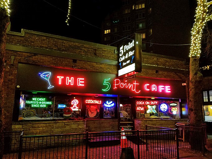 The 5 Point's iconic brick exterior and neon signage beckons like an old friend, promising comfort food and zero pretension in Seattle's bustling Belltown neighborhood.