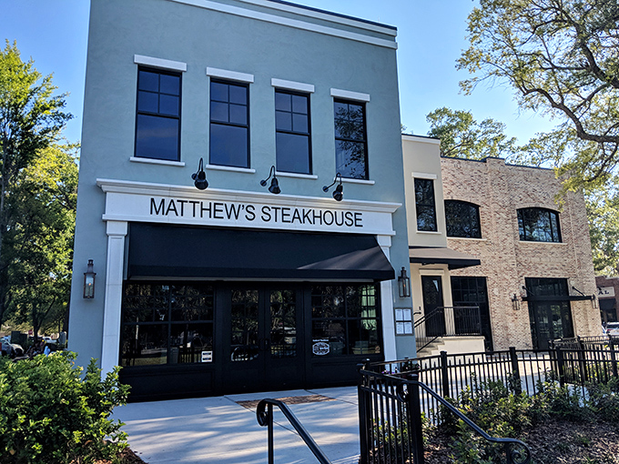 The elegant white façade of Matthew's Steakhouse stands like a culinary beacon in Winter Garden's historic district, promising memorable meals behind those stylish black-framed doors.