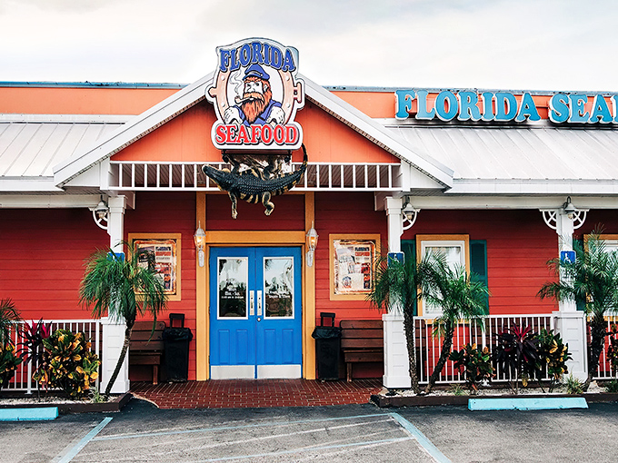 The coral-colored exterior with bright blue doors isn't just eye-catching—it's practically shouting "Fresh seafood inside!" like a friendly maritime beacon.