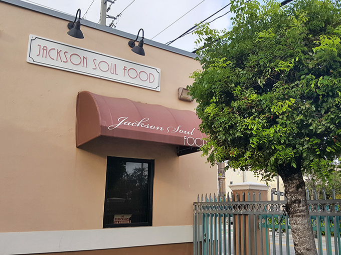 The unassuming peach-colored exterior with its burgundy awning is Miami's soul food beacon – no flash, just pure culinary promise waiting inside.