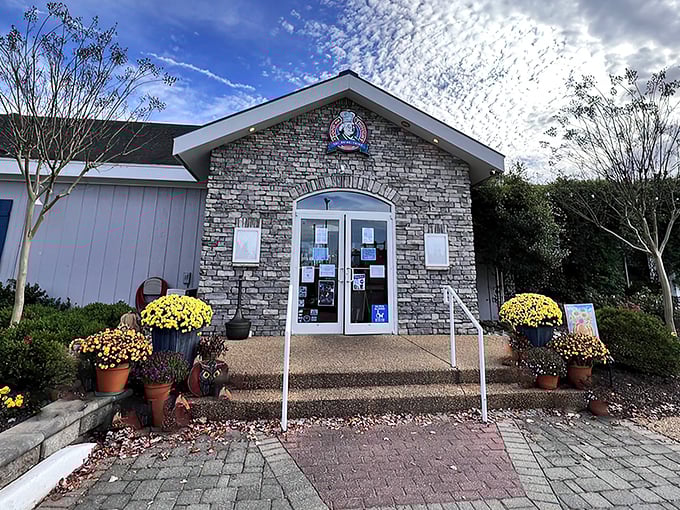 The welcoming exterior of Food For Thought beckons with colorful landscaping and a promise of culinary enlightenment. That American flag isn't just patriotic—it's signaling your taste buds to stand at attention.