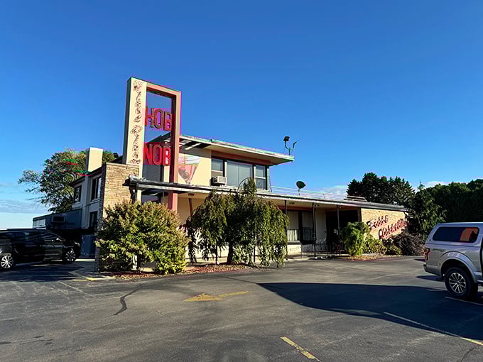 The iconic red HOBNOB sign stands tall against the Wisconsin sky, a beacon for prime rib pilgrims and supper club aficionados for generations.