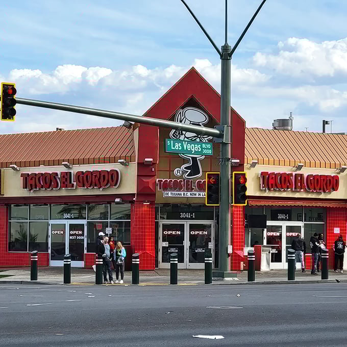 The vibrant red exterior of Tacos El Gordo stands out like a beacon of hope for hungry souls wandering the Las Vegas desert.