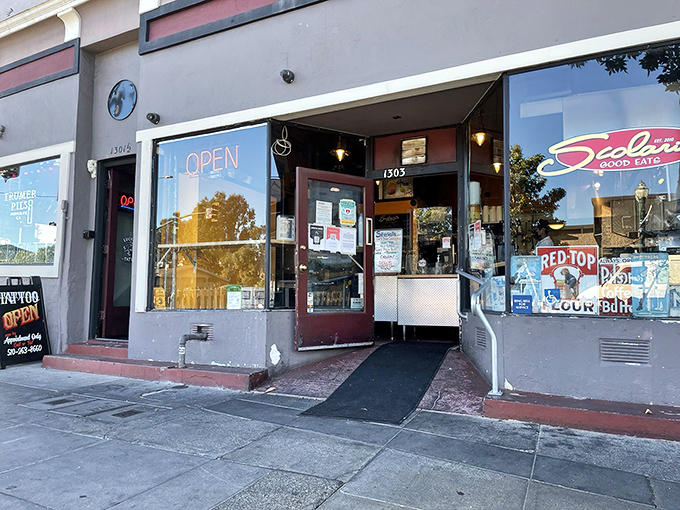 The unassuming storefront of Scolari's Good Eats beckons with its red neon "OPEN" sign—like a lighthouse guiding hungry sailors to delicious shores.