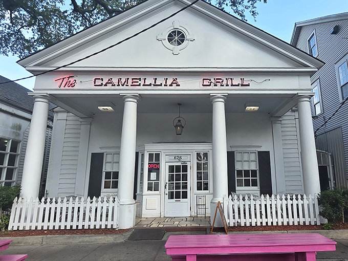 A Greek revival facade that houses burgers instead of philosophy—The Camellia Grill's columned entrance promises Southern hospitality with a side of architectural charm.