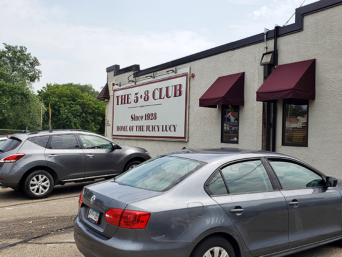 The unassuming exterior of 5-8 Club hides culinary greatness behind those burgundy awnings, proving that in Minnesota, legendary burgers don't need fancy facades.
