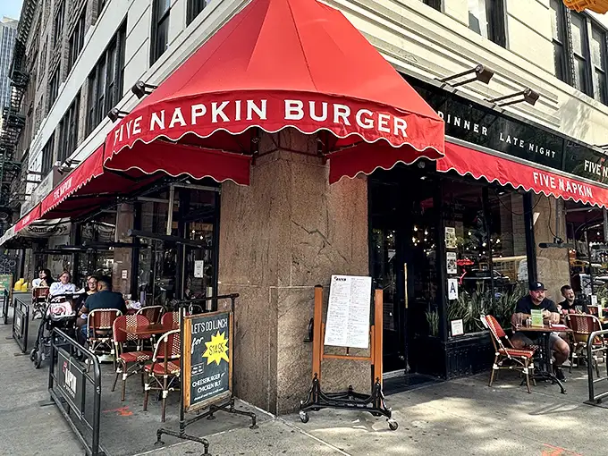That iconic red awning is like a beacon for burger lovers navigating the urban jungle. Sidewalk seating beckons with prime people-watching possibilities.
