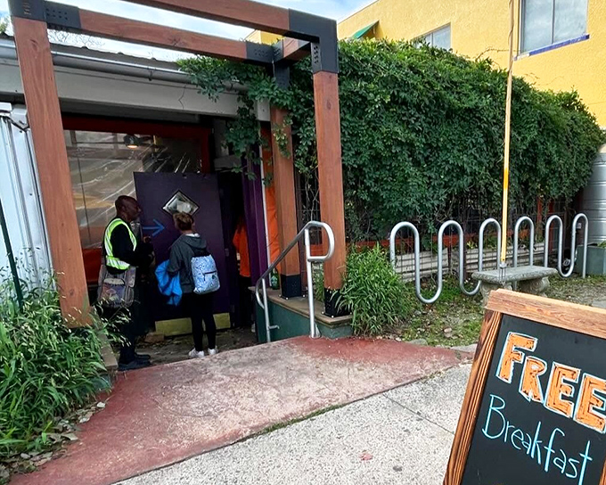 The iconic blue sign says it all – people aren't just waiting for breakfast, they're queuing for a culinary pilgrimage at Sunny Point Café.