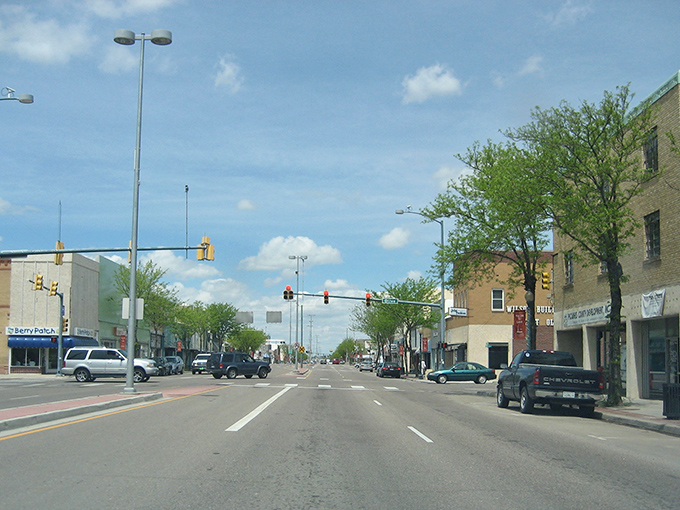 Main Street Lamar welcomes visitors with its classic small-town charm. Those red banners aren't just decorative—they're practically waving "affordable living this way!"